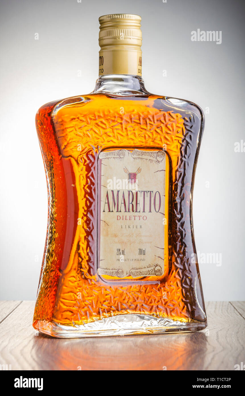 Bottle of Amaretto liqueur on gradient background. Amaretto comes from ...
