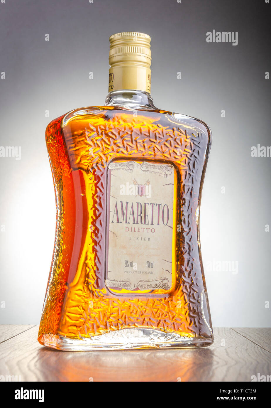 Bottle of Amaretto liqueur on gradient background. Amaretto comes from ...