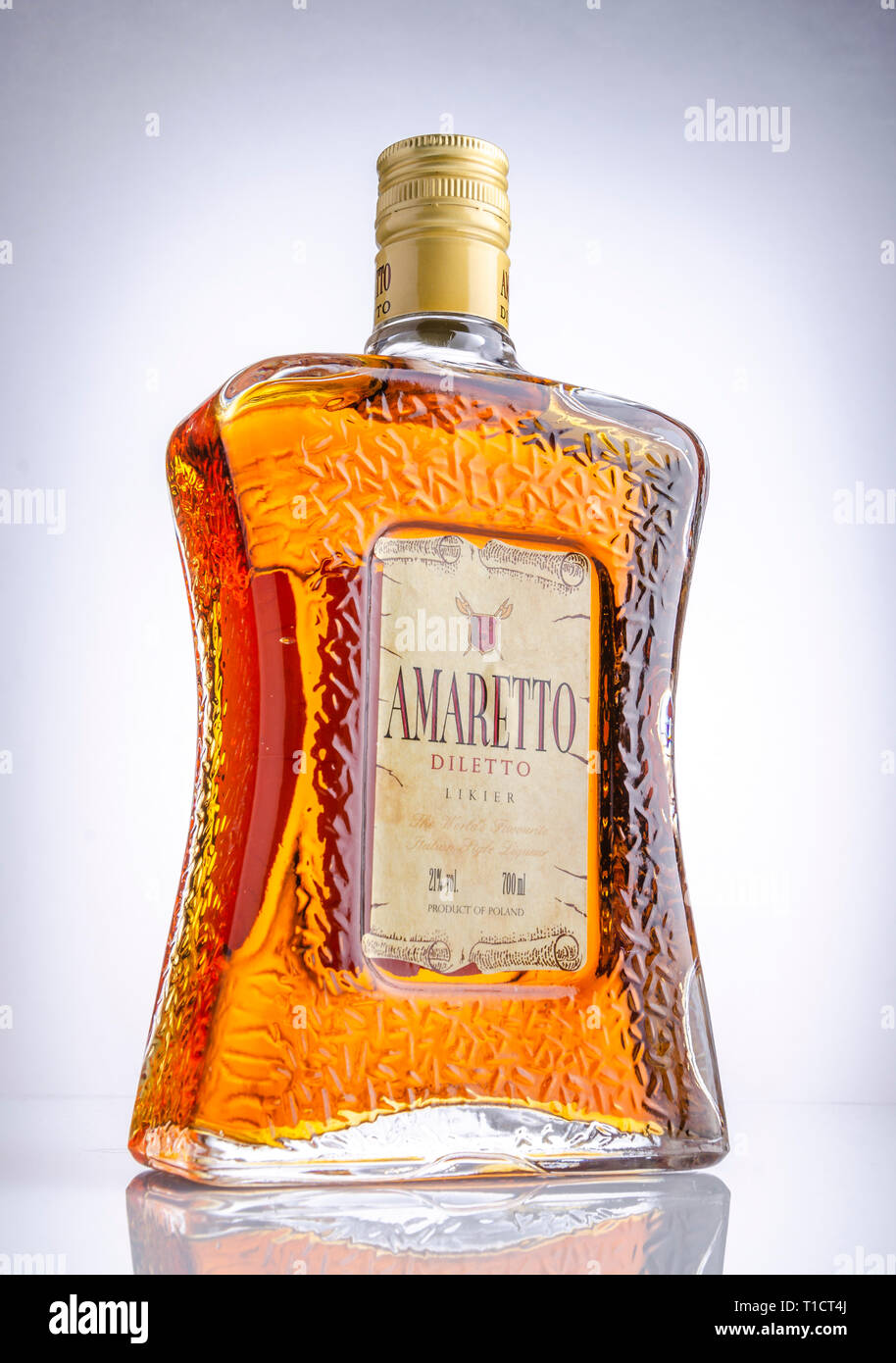 Bottle of Amaretto liqueur on gradient background. Amaretto comes from ...