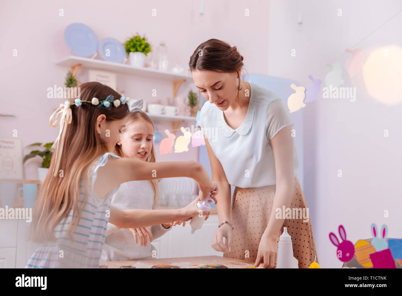 Positive delighted kids spending time with their mom Stock Photo - Alamy