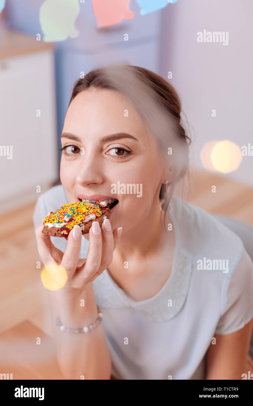 Amazing female person enjoying tasty handmade cookie Stock Photo - Alamy