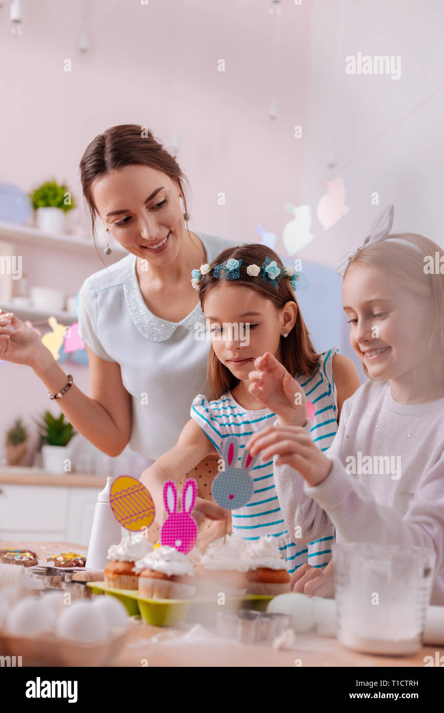 Positive delighted woman spending time with daughters Stock Photo - Alamy