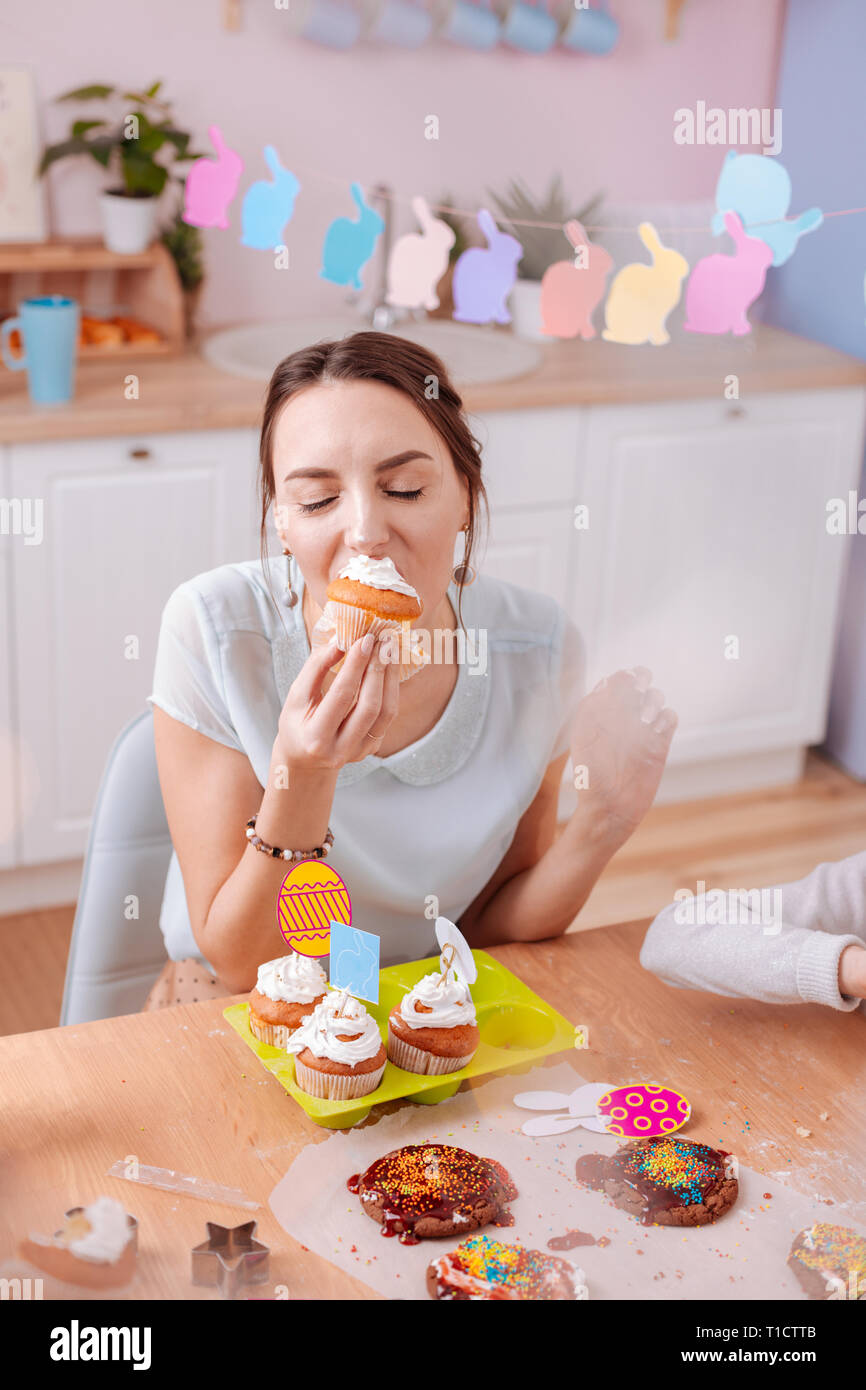 Hungry young woman eating sweets with great pleasure Stock Photo - Alamy