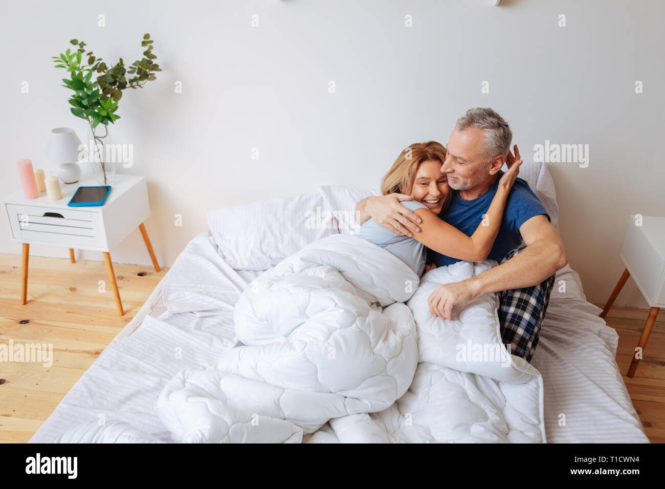 Cheerful beaming wife hugging her strong supportive man Stock Photo - Alamy