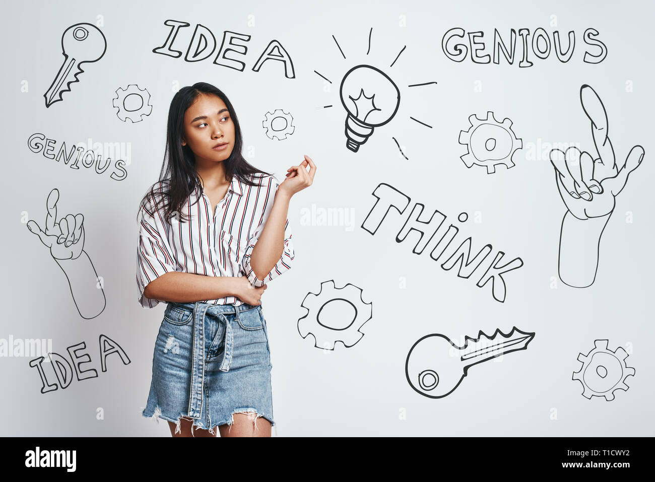 Genius lady. Cute asian young woman in casual wear is thinking and ...