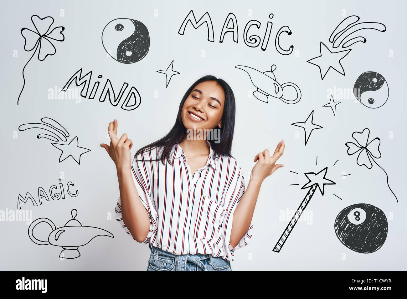 I am making my dreams true. Smiling young asian women in striped shirt ...