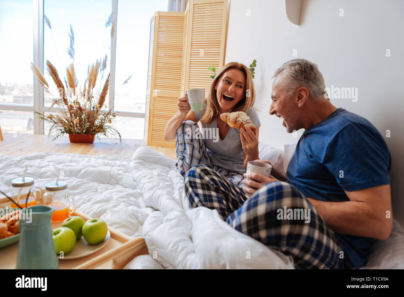 Wife feeling excited before trying croissant in the morning Stock Photo ...