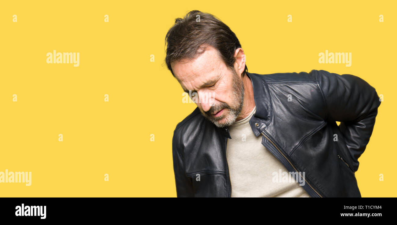 Middle age handsome man wearing black leather jacket Suffering of ...