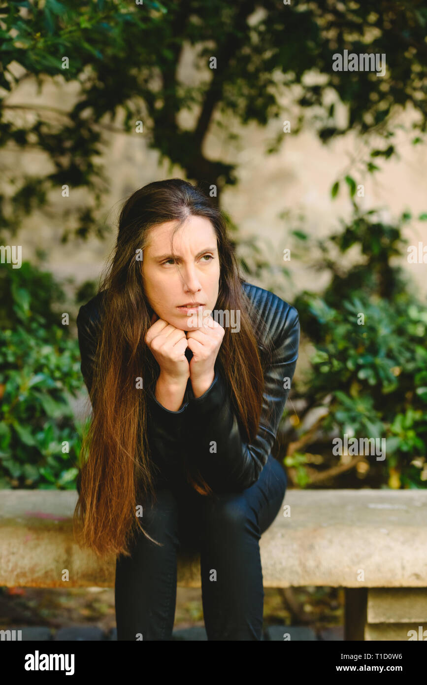 Serious and doubtful young woman with unsure face, feeling uncertain ...