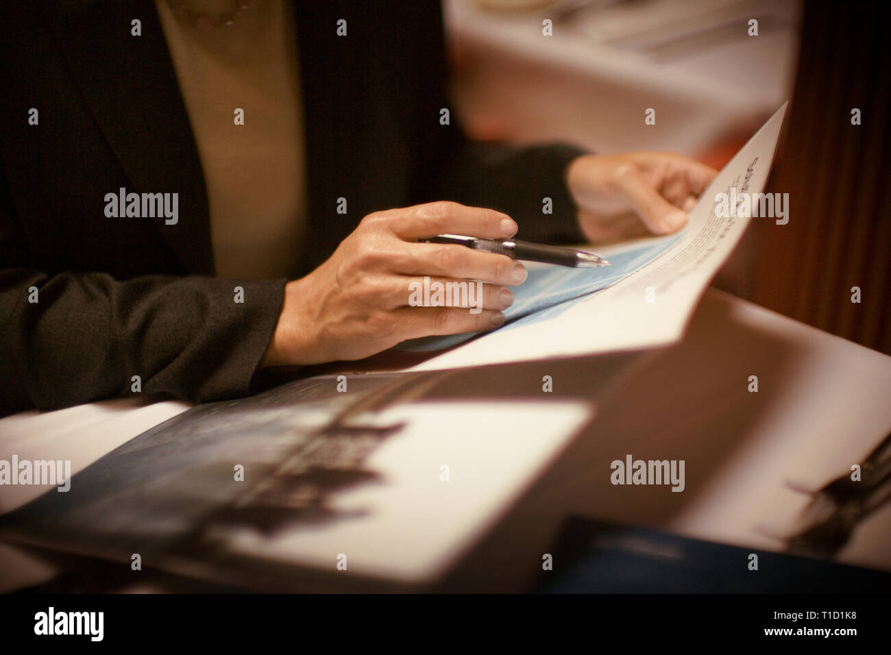 Documents being read by a woman Stock Photo - Alamy
