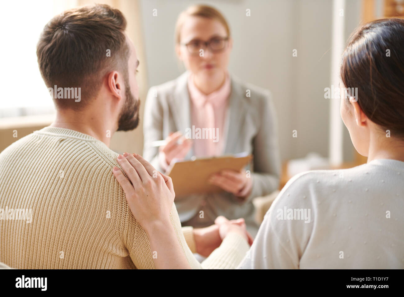 Couple consulting with counselor Stock Photo - Alamy