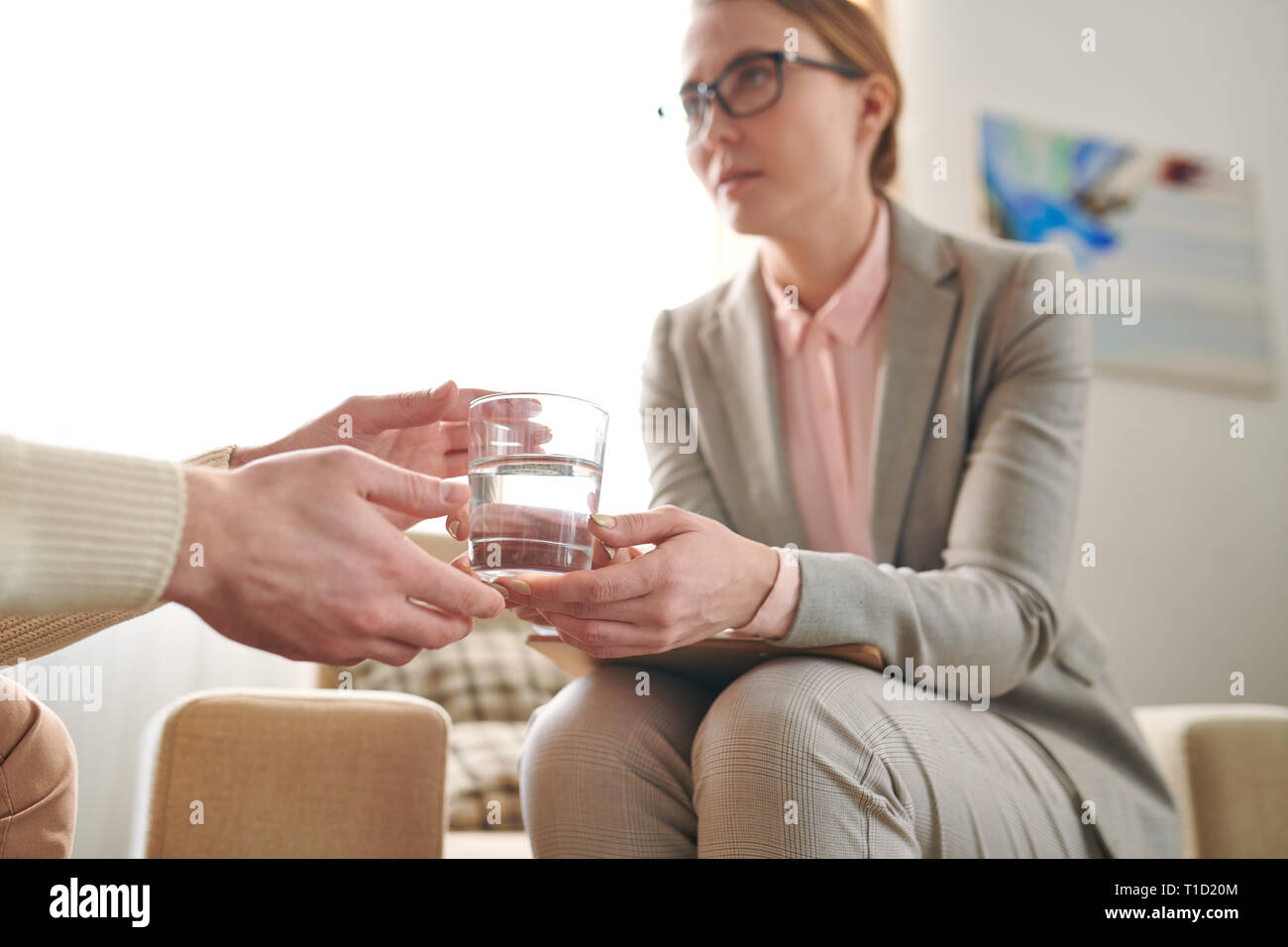 Passing water to patient Stock Photo - Alamy