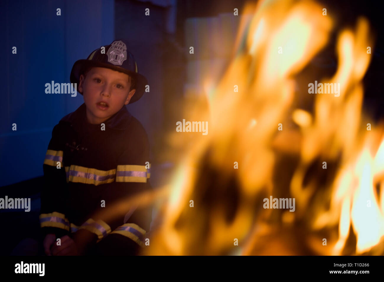 View of a boy sitting near fire Stock Photo - Alamy