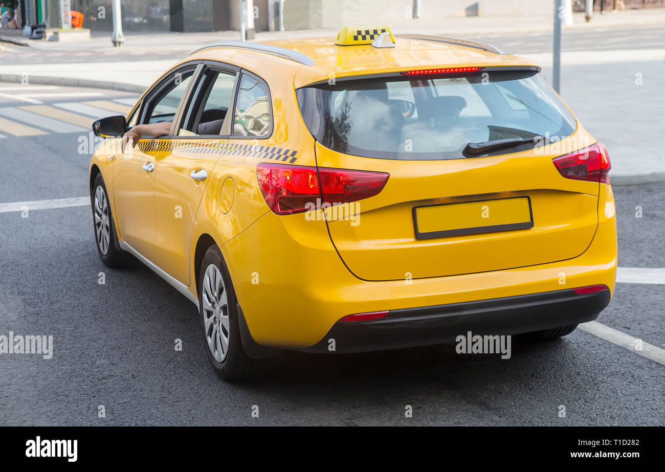 yellow taxi moves on the city street Stock Photo - Alamy