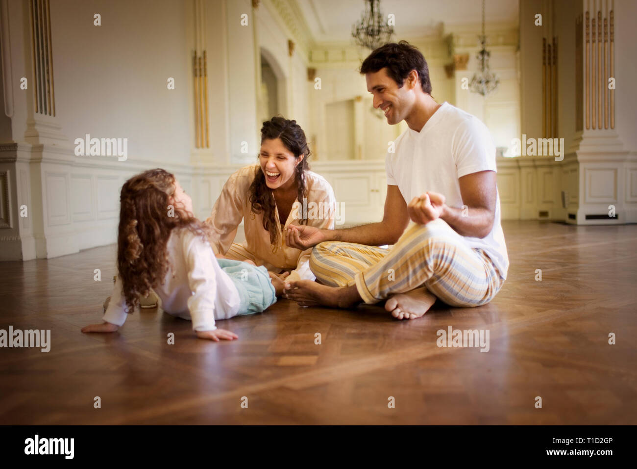 View of a family sitting together happily Stock Photo - Alamy