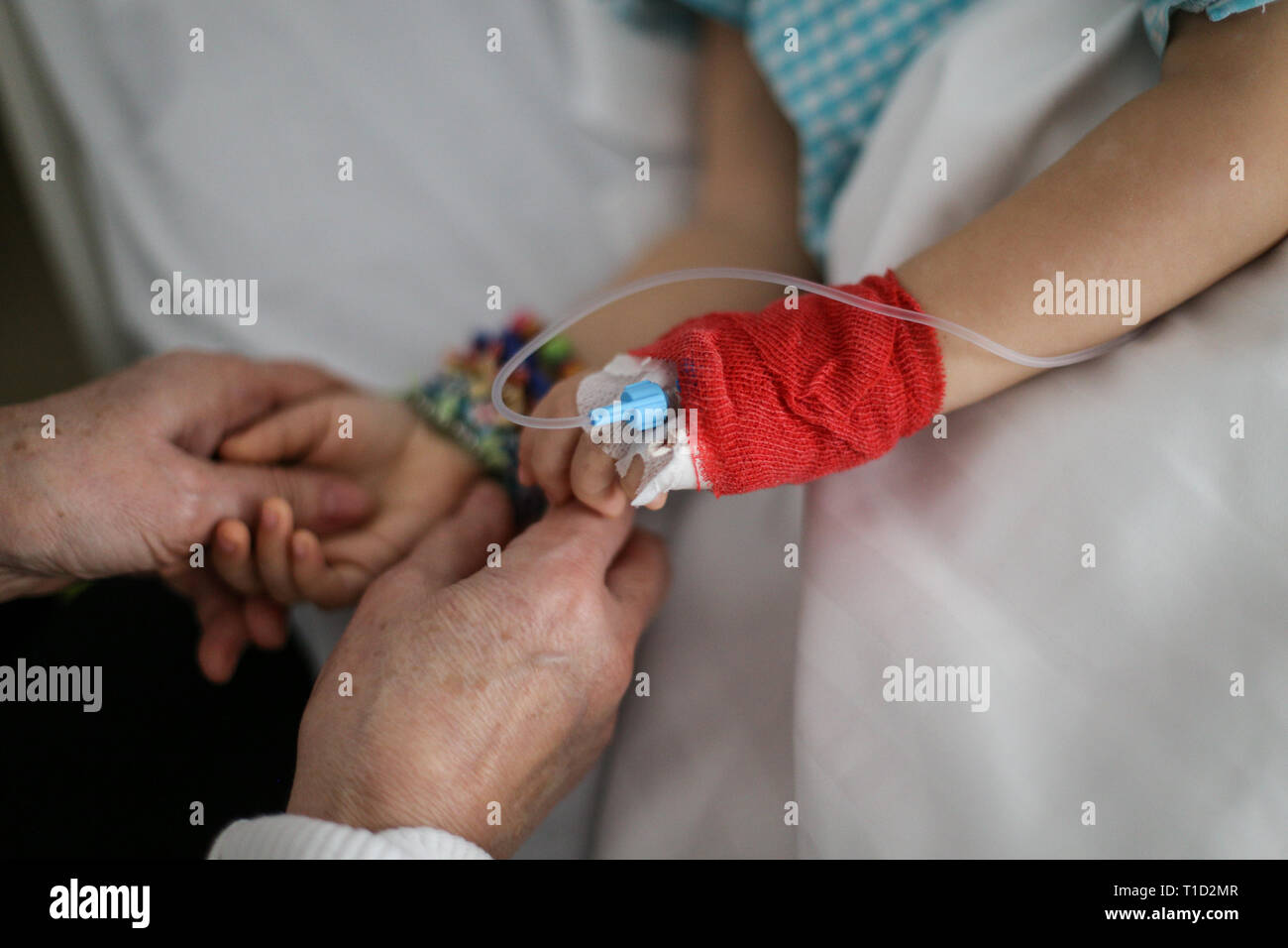 Details with the hands of a grandmother comforting her granddaughter ...