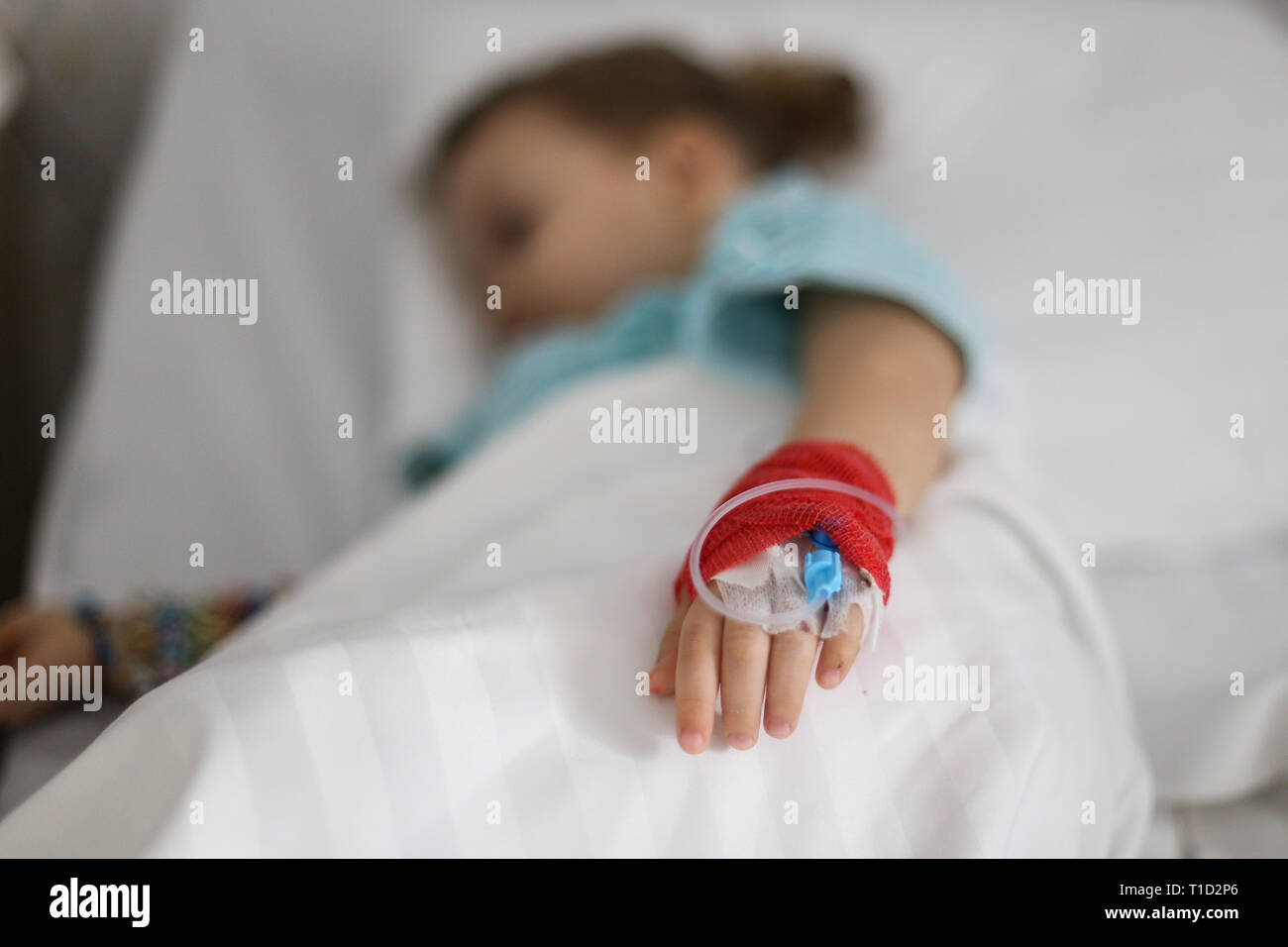 Details with a cannula on the hand of a ill little girl in a pediatric ...
