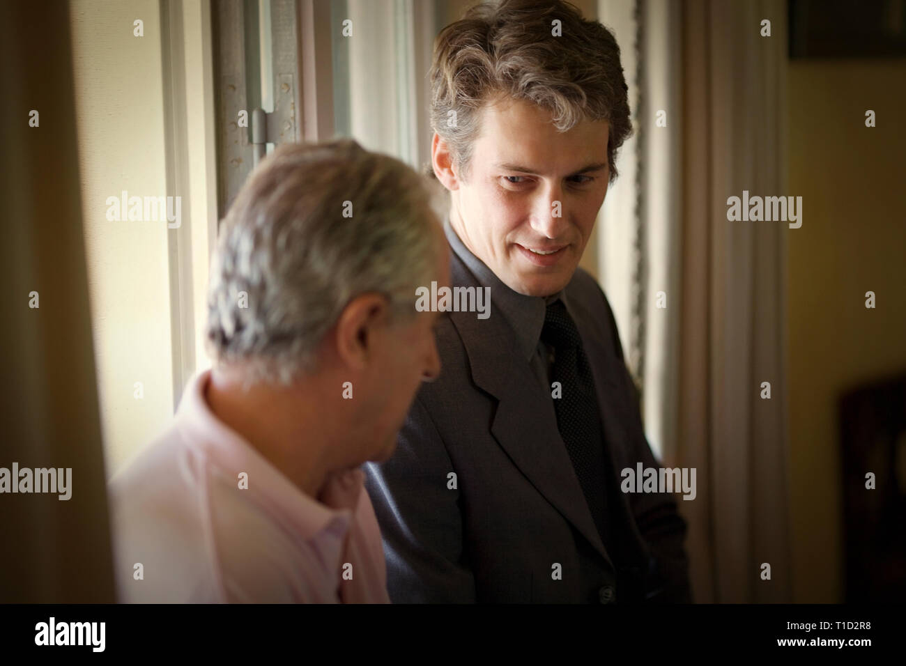 Side view of two men in a conversation Stock Photo - Alamy
