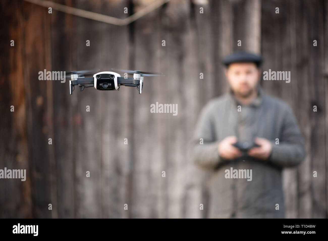 Old fashioned men from village mastering to fly drone, basics of remote ...