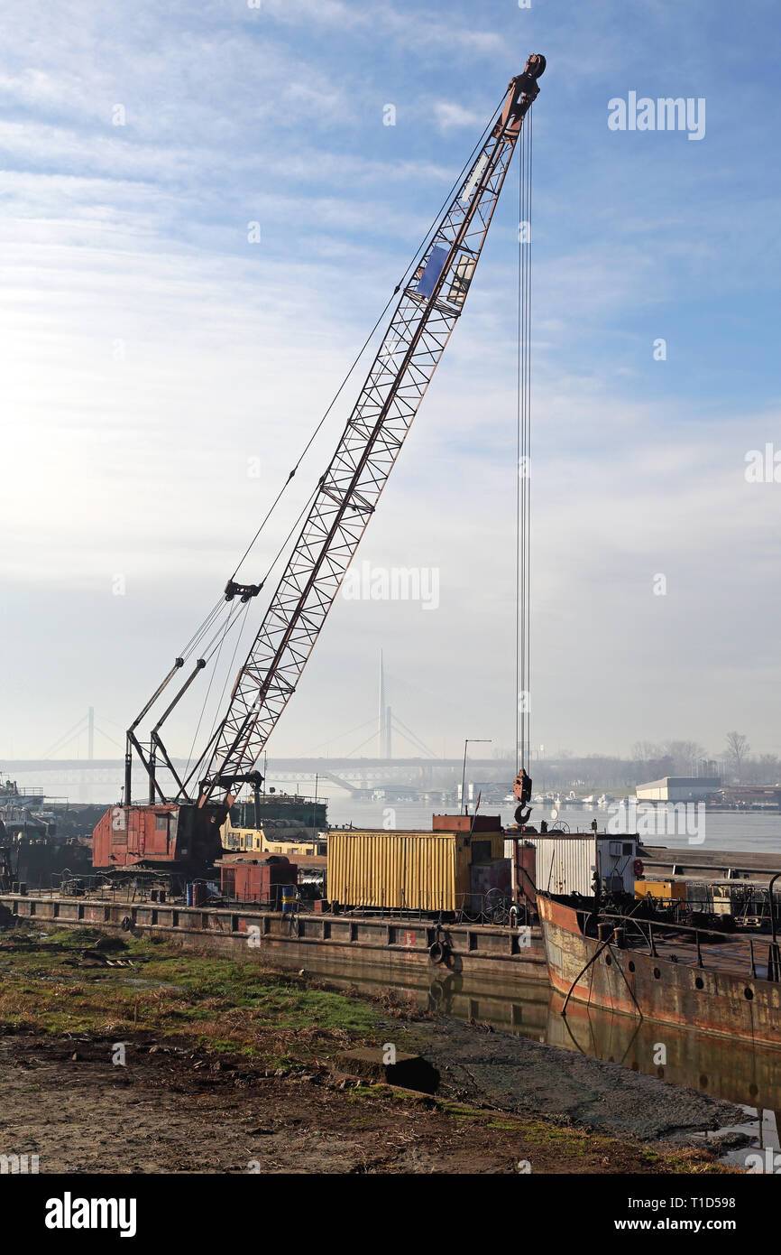 Tall Crane at Barge Stacked in River Mud Stock Photo - Alamy