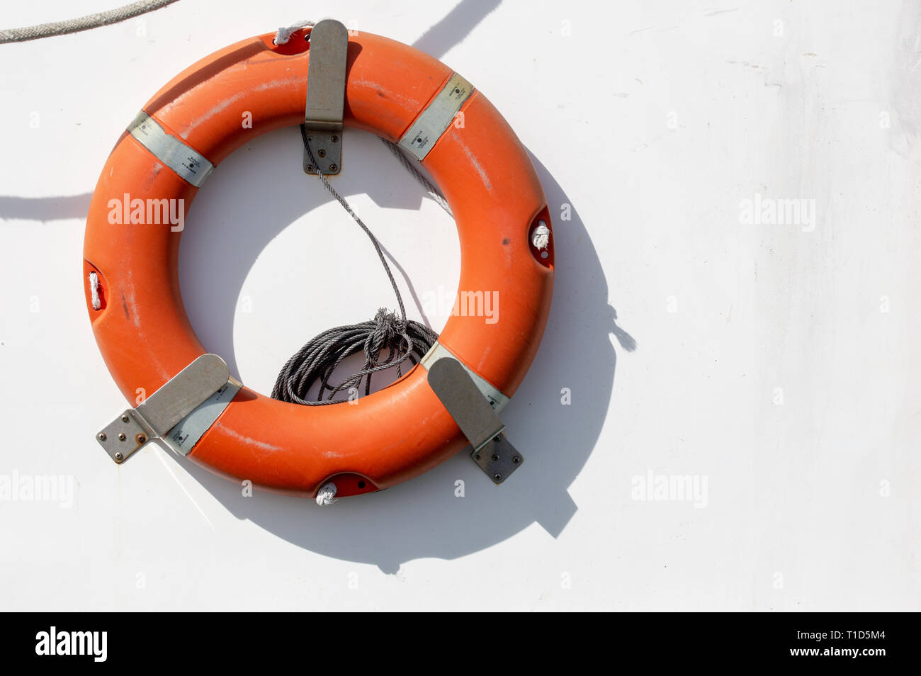 Red emergency lifebuoy hanging on the side of a fishing boat Stock ...