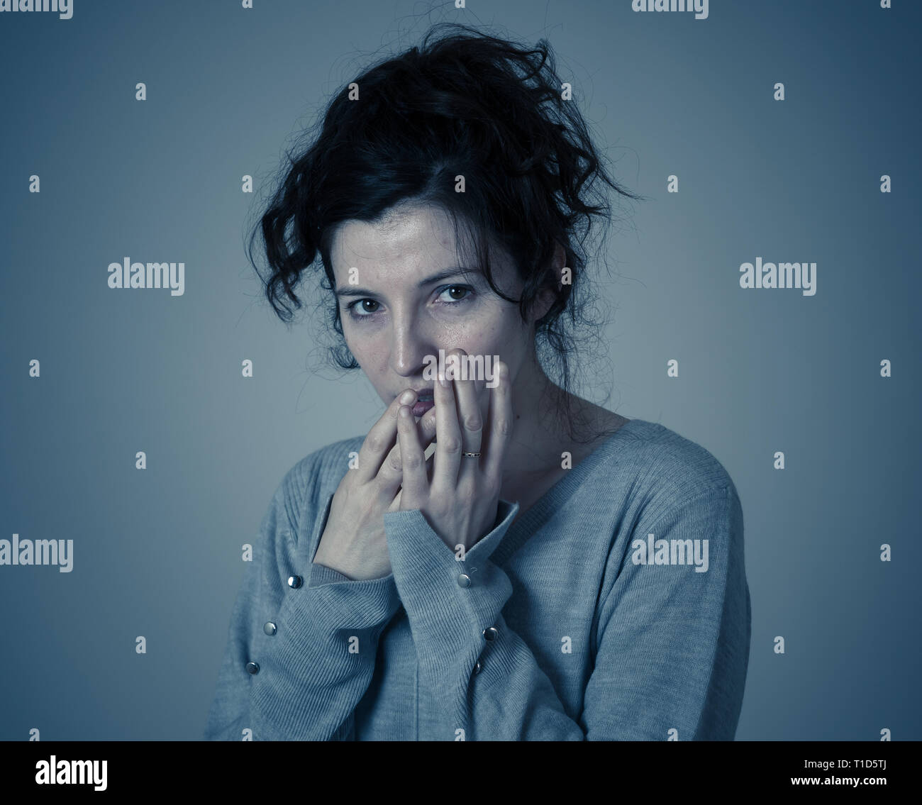 Close up of young scared and frightened woman, covering herself from ...
