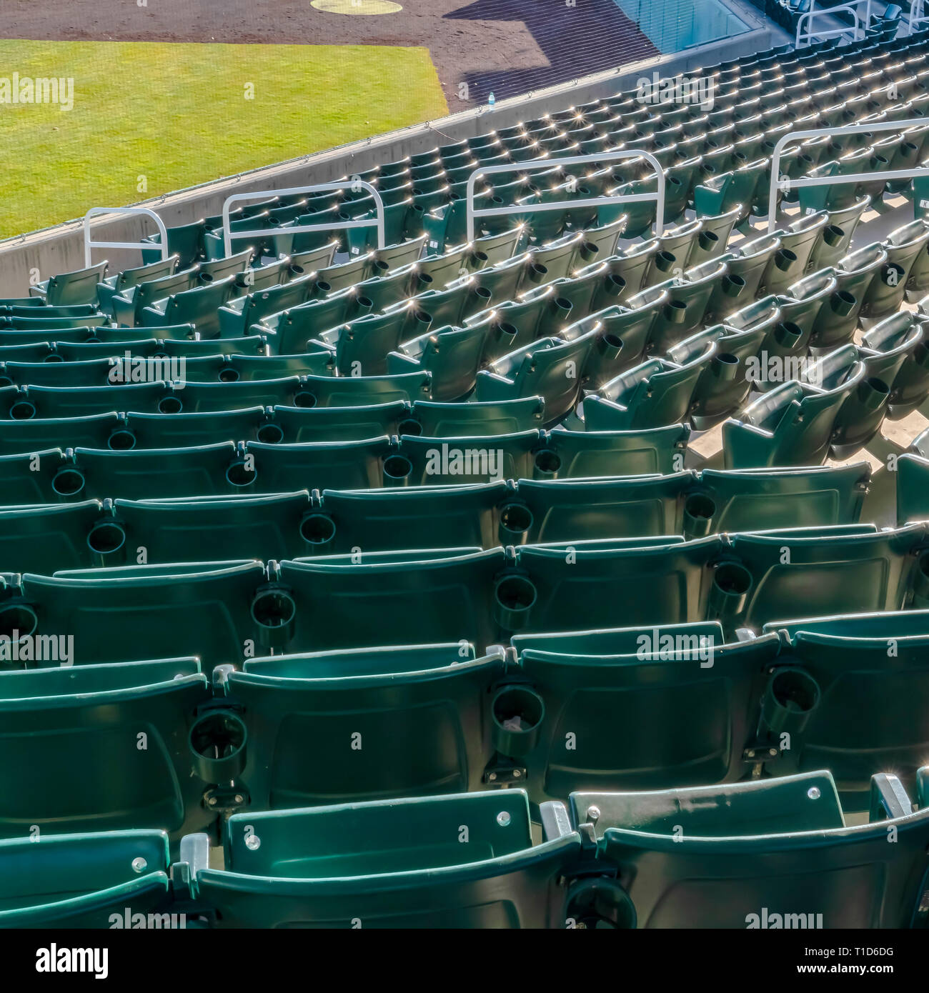 Tiers of green seats for spectators at a stadium. Tiers of green seats ...