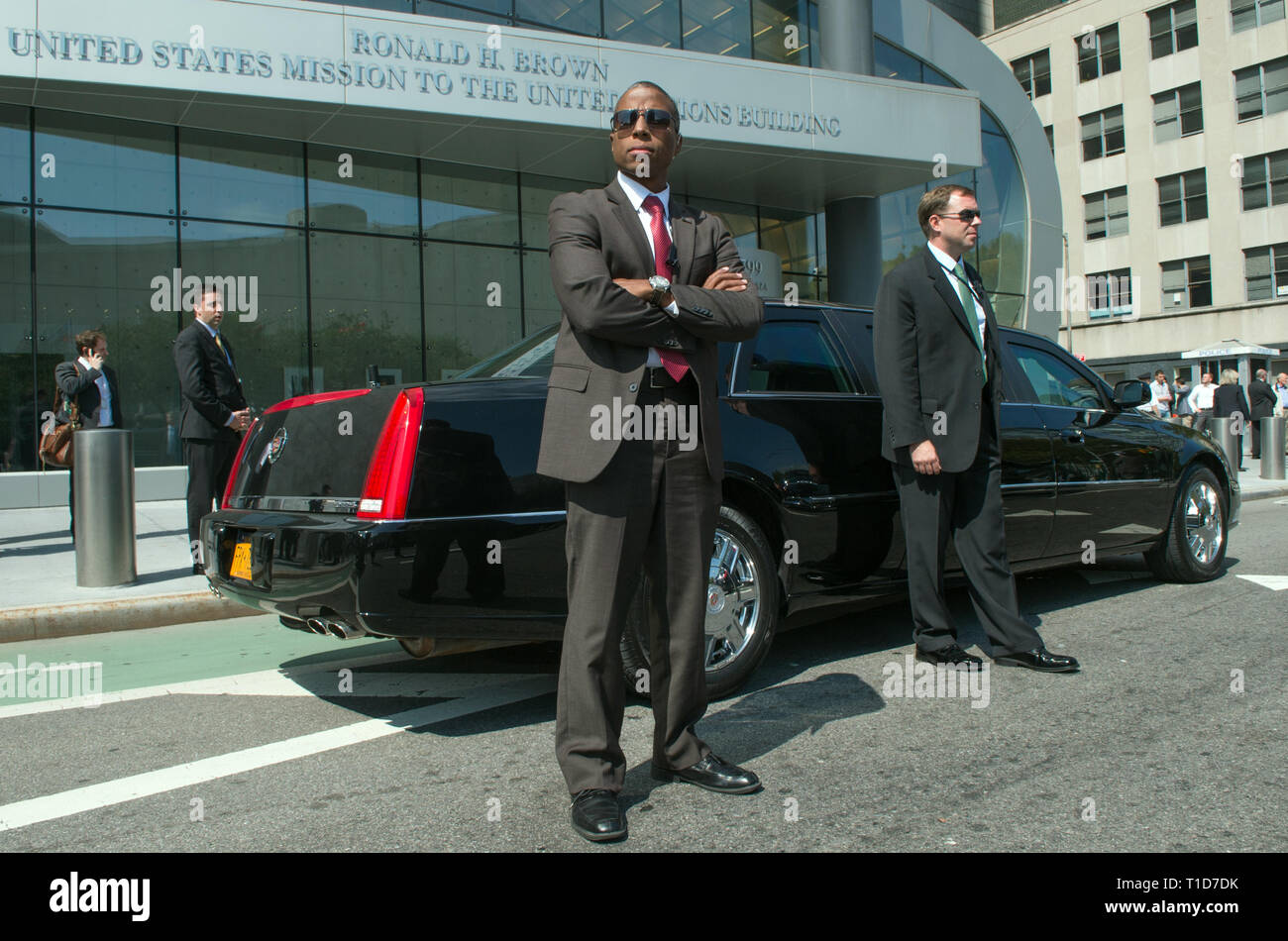 Two secret service men standing outside of a car in New York City Stock ...