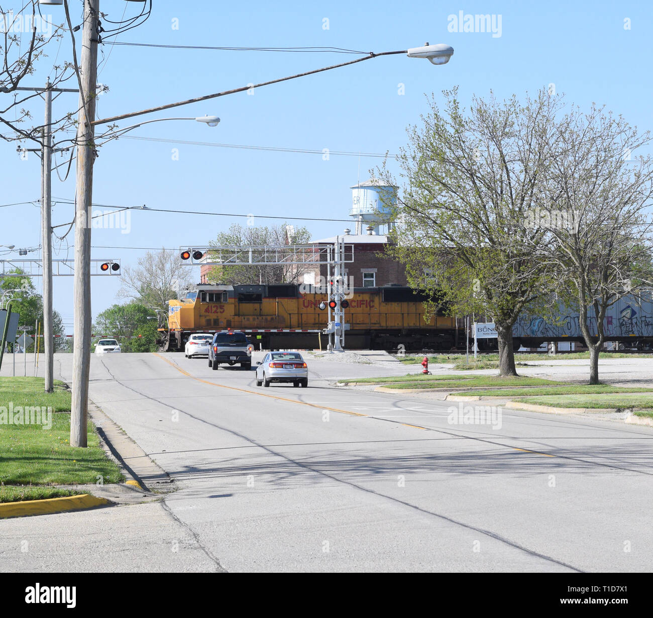 Cars waiting at a railroad crossing in Homer Illinois as a Union ...
