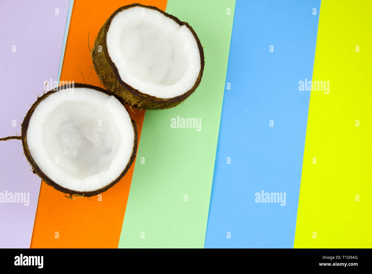 coconut on stripped multicolored background Stock Photo - Alamy