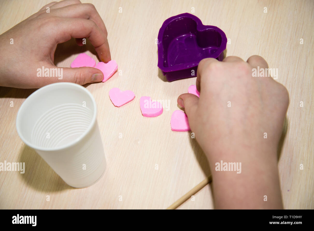 Process of homemade soap, mixing lye solution into oil. Making a gift ...