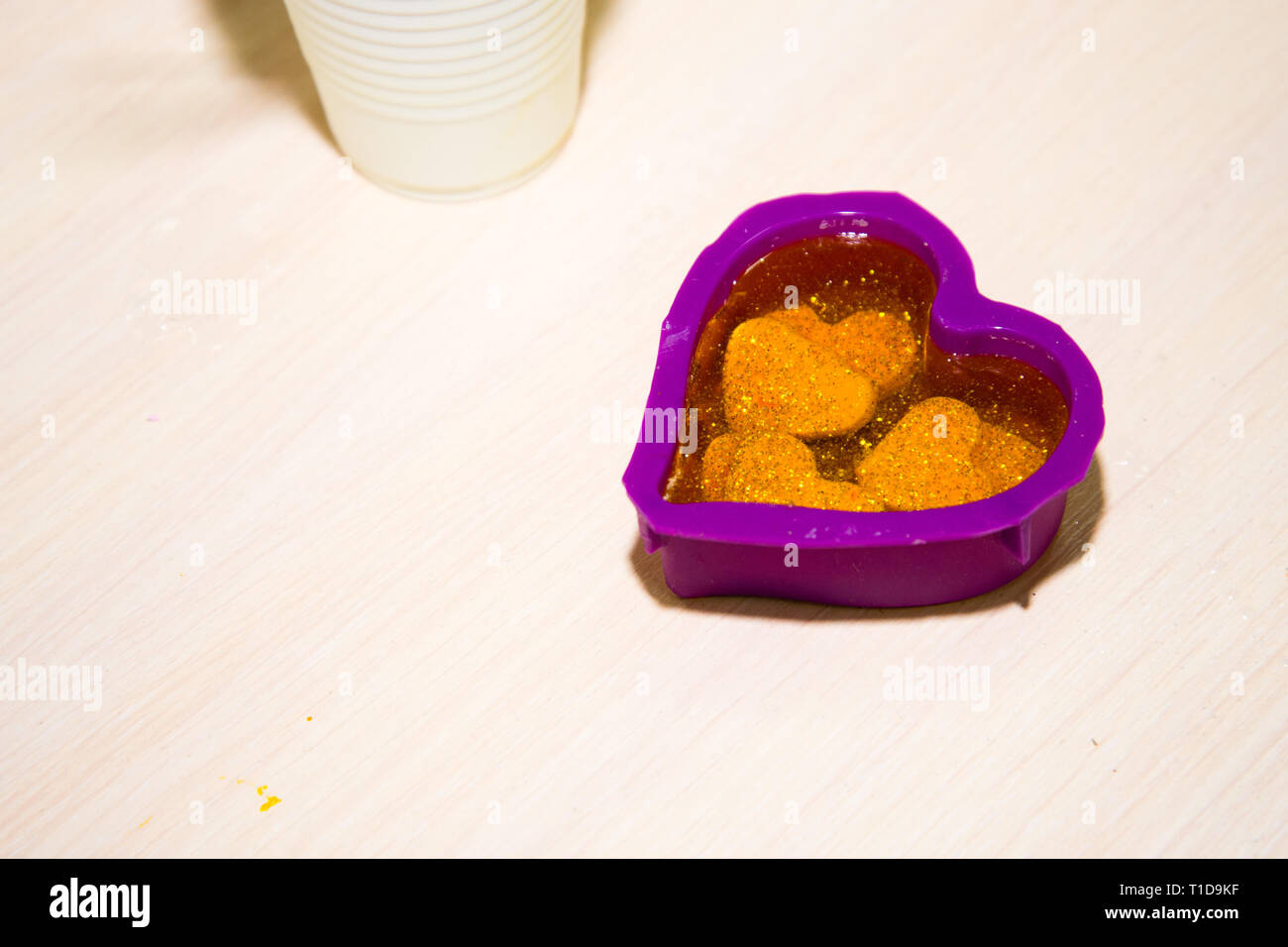 Process of homemade soap, mixing lye solution into oil. Making a gift ...