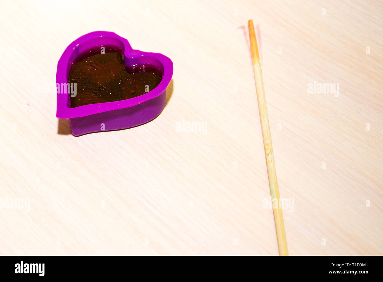 Process of homemade soap, mixing lye solution into oil. Making a gift ...