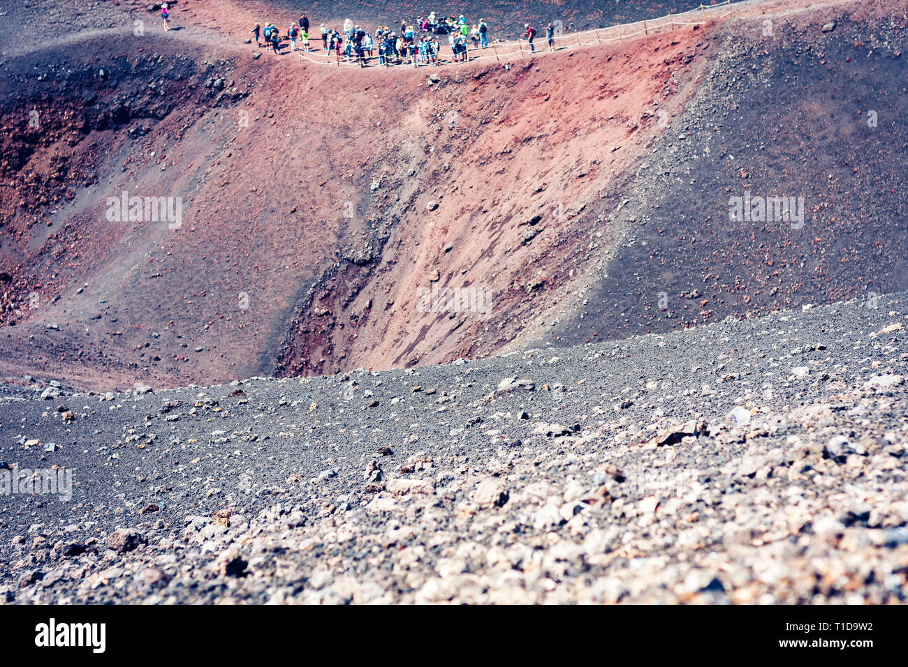 People walking on Mount Etna, active volcano on the east coast of ...