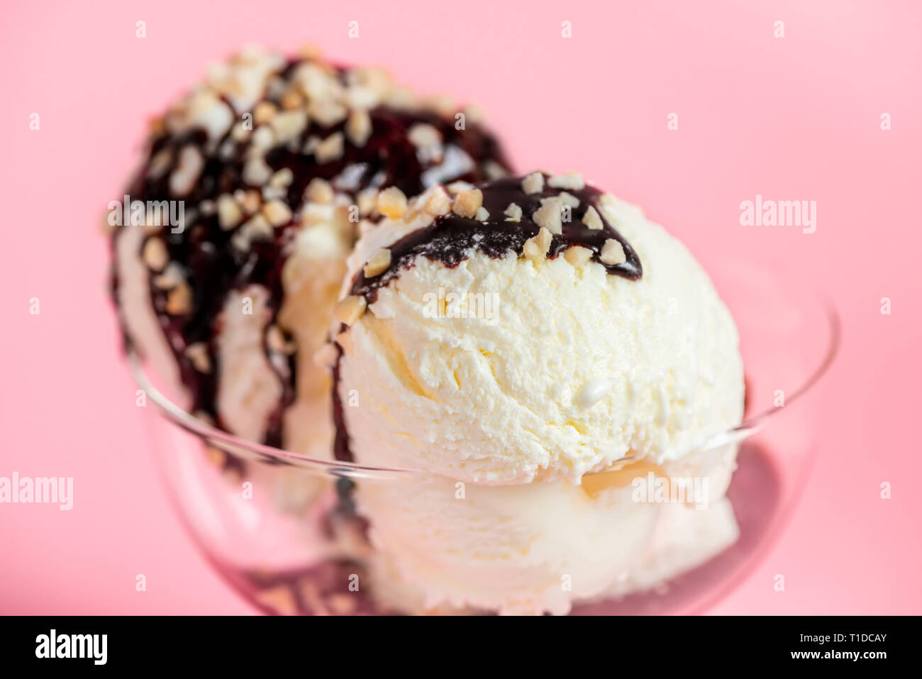 scoops white ice cream decorated chocolate topping and nuts on vase ...