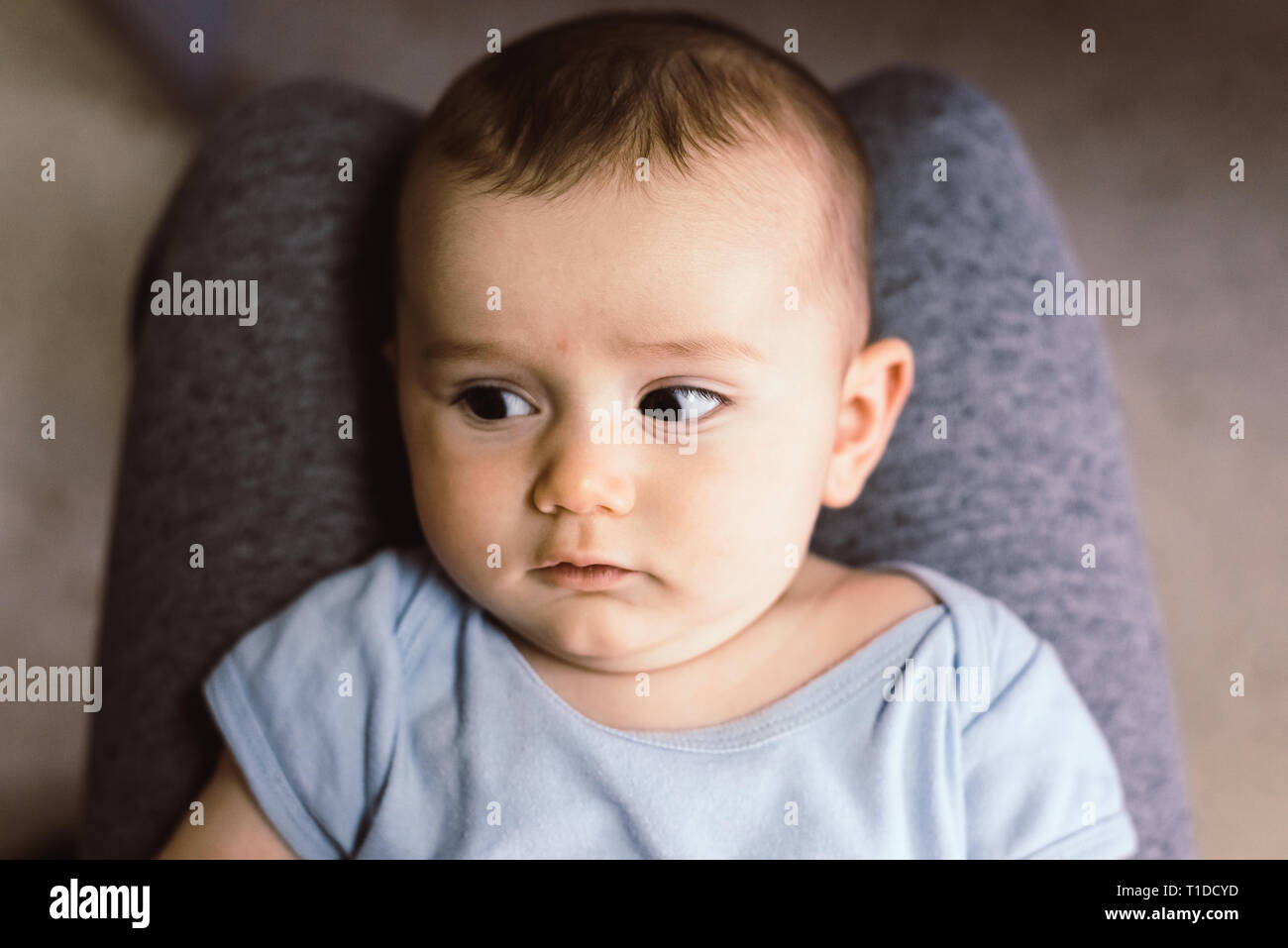 Portrait of the round face of a baby on his mother's legs Stock Photo ...