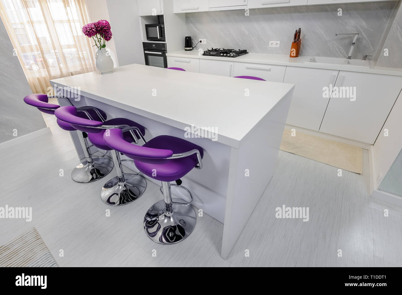 white dining table in modern kitchen Stock Photo - Alamy