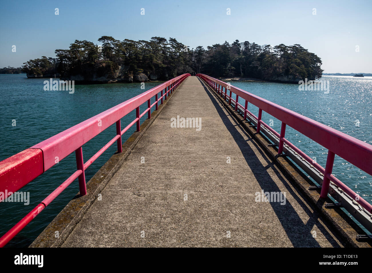 On the coast of Matsushima, Japan, a small bridge with red railings ...