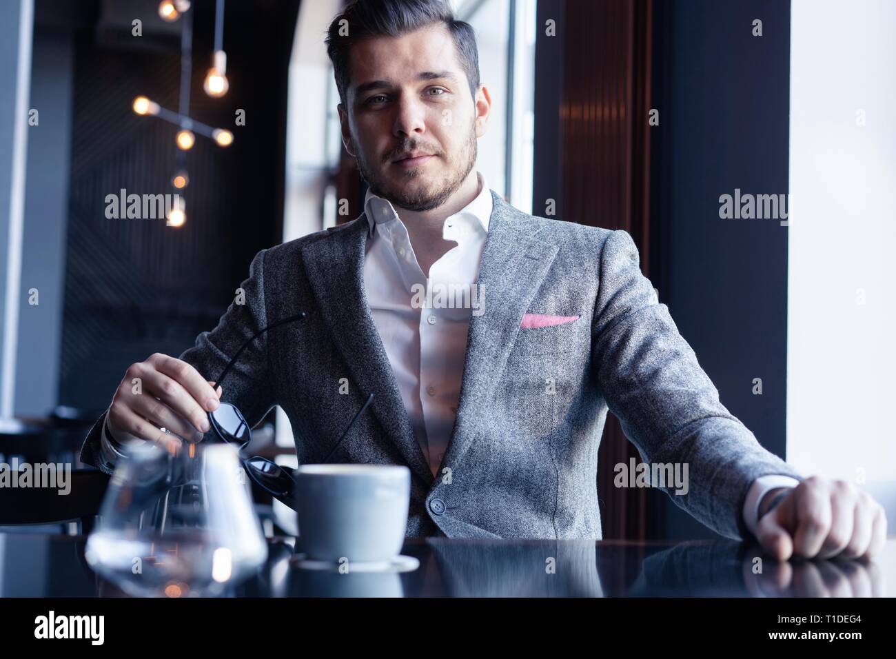 Business man drinking coffee in a cafe - coffee time Stock Photo - Alamy