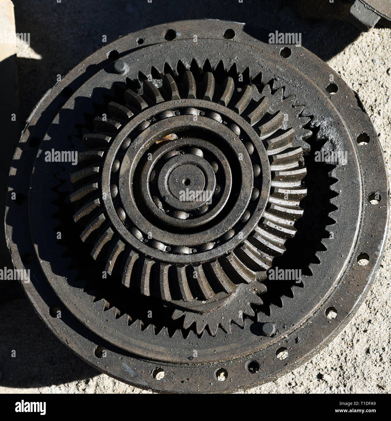 Metal cog gears joining together from tractor Stock Photo - Alamy