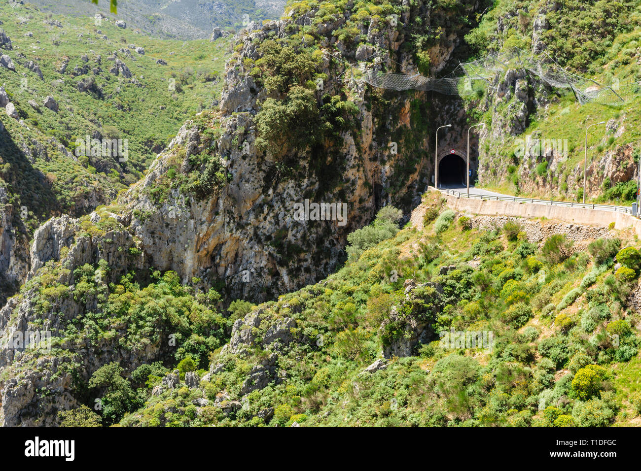 Road with tunnel through the Topolia Gorge, canyon in Crete, Greece ...
