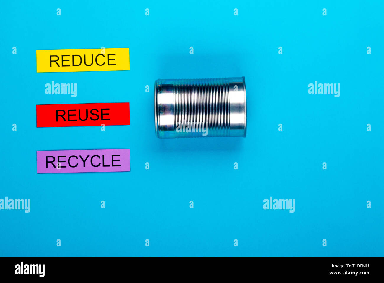 Recycle concept showing reduce, reuse & recycle with cans on a blue ...