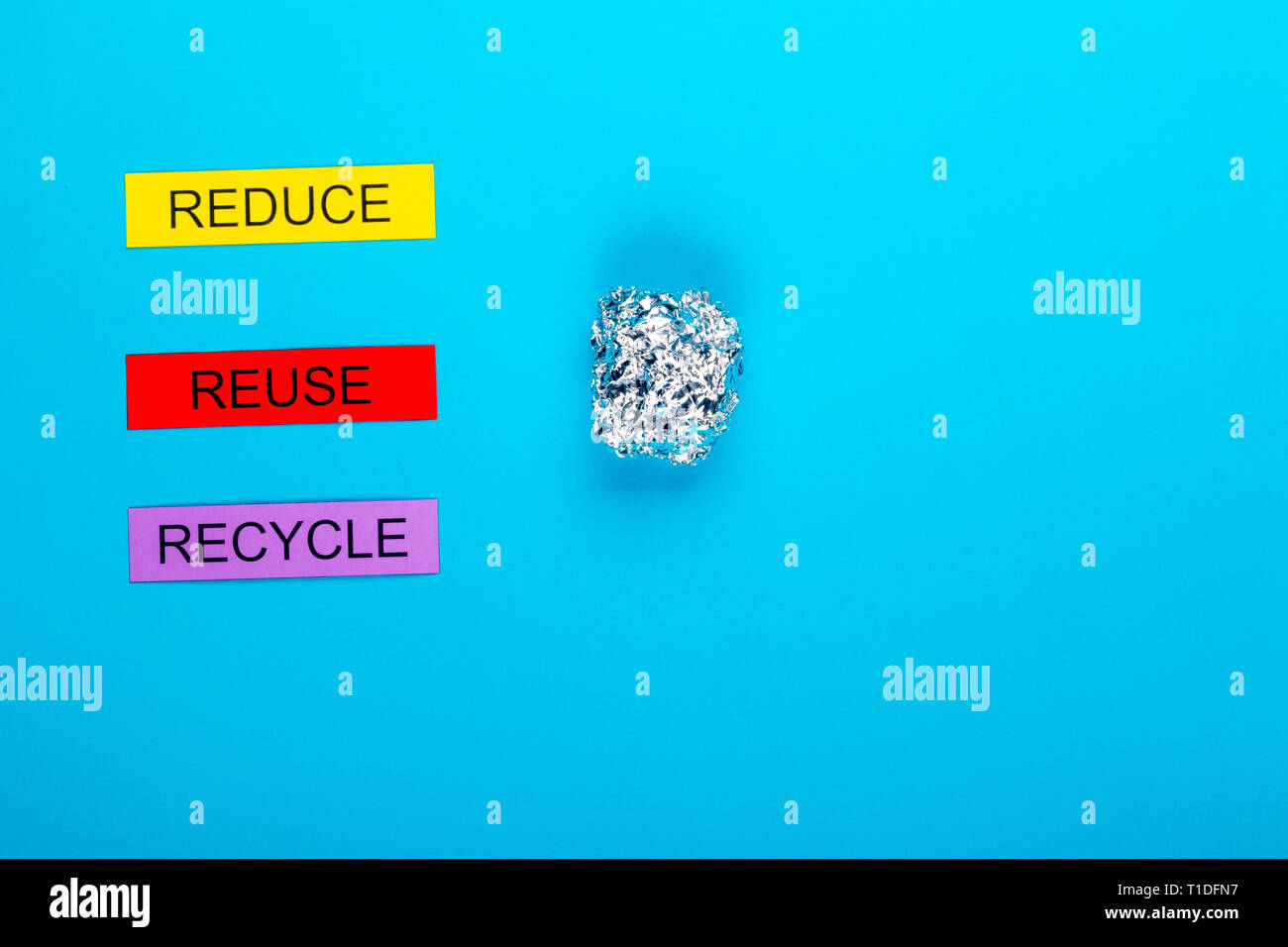 Recycle concept showing reduce, reuse & recycle with foil on a blue ...