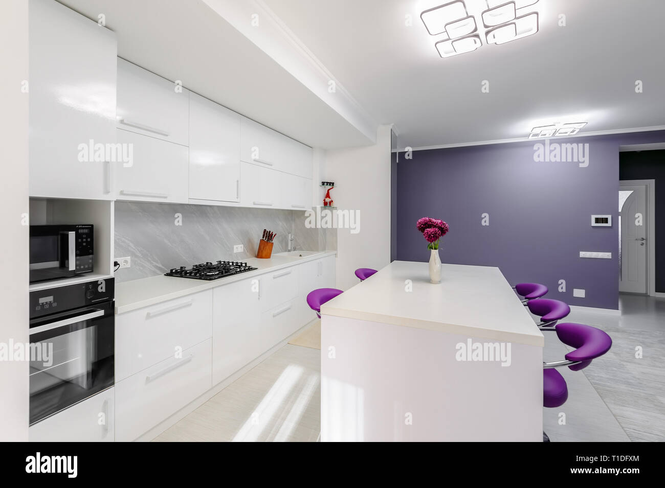 white dining table in modern kitchen Stock Photo - Alamy