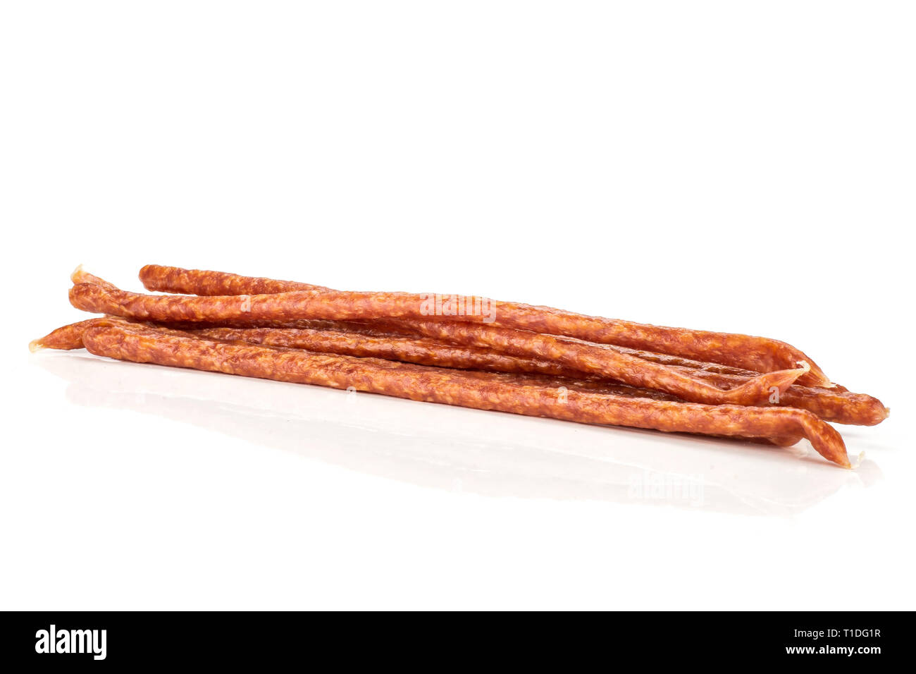 Lot of whole spicy salami stick tyrolini isolated on white background ...