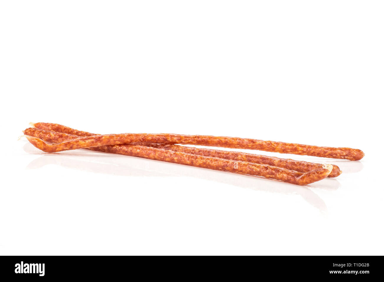 Group of three whole spicy salami stick tyrolini isolated on white ...
