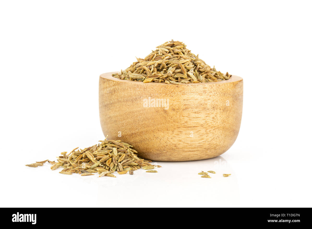 Lot of whole roman caraway seeds with wooden bowl isolated on white ...