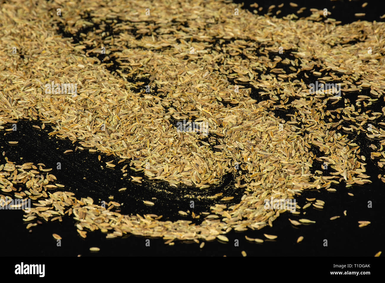 Lot of whole roman caraway seeds isolated on black Stock Photo - Alamy