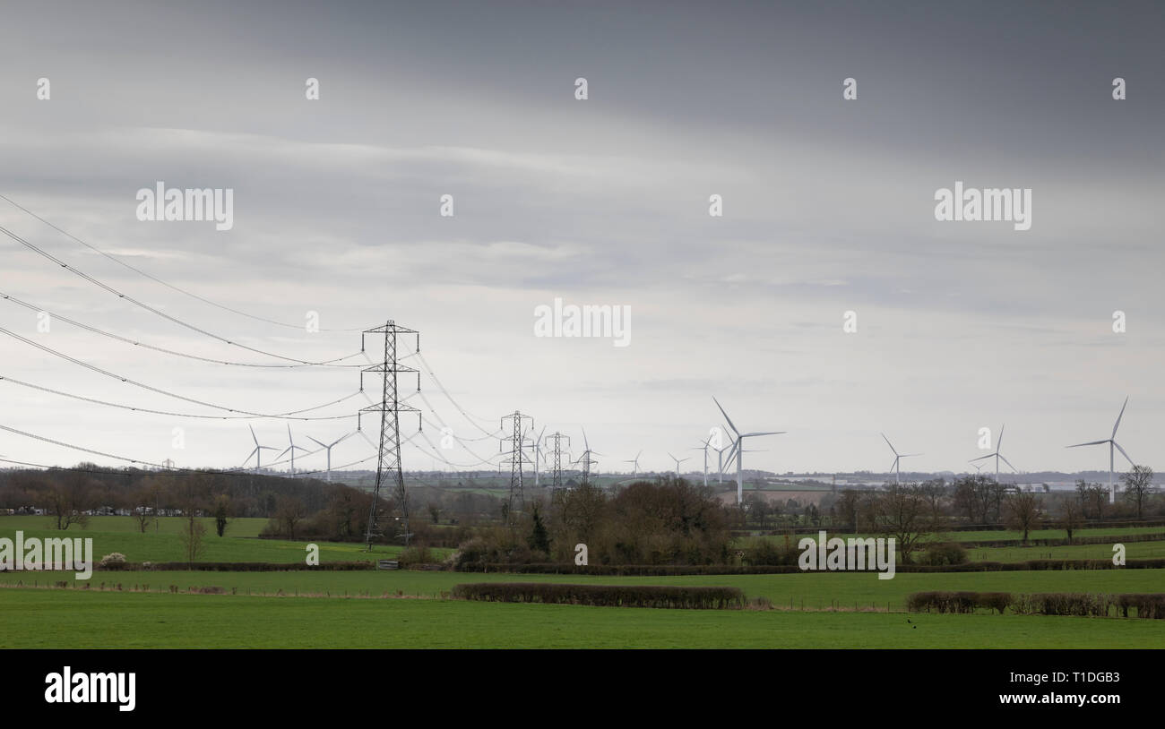 An image of a wind farm and electricity pylons both producing power to ...