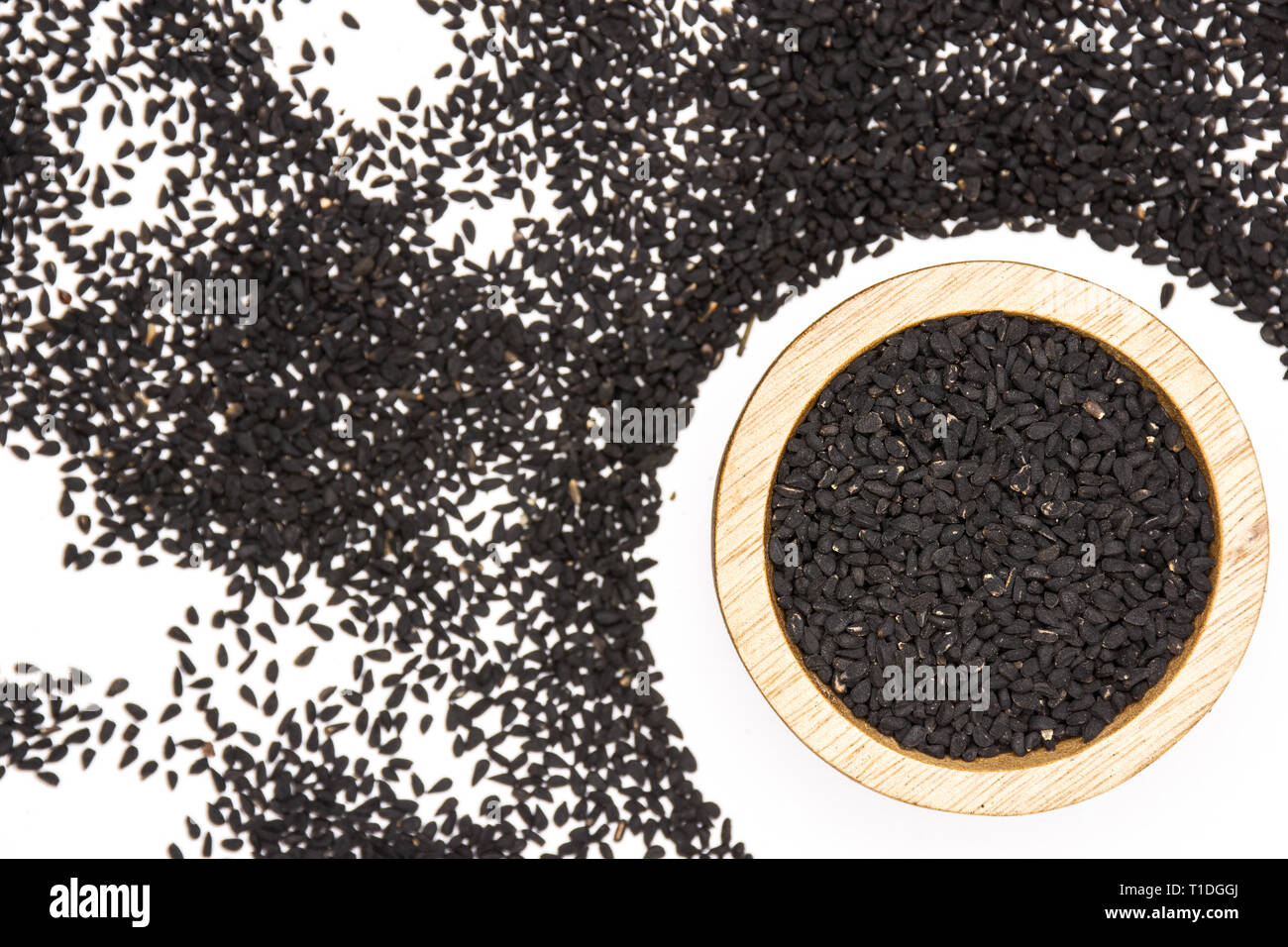 Lot of whole black cumin seeds with wooden bowl flatlay isolated on ...